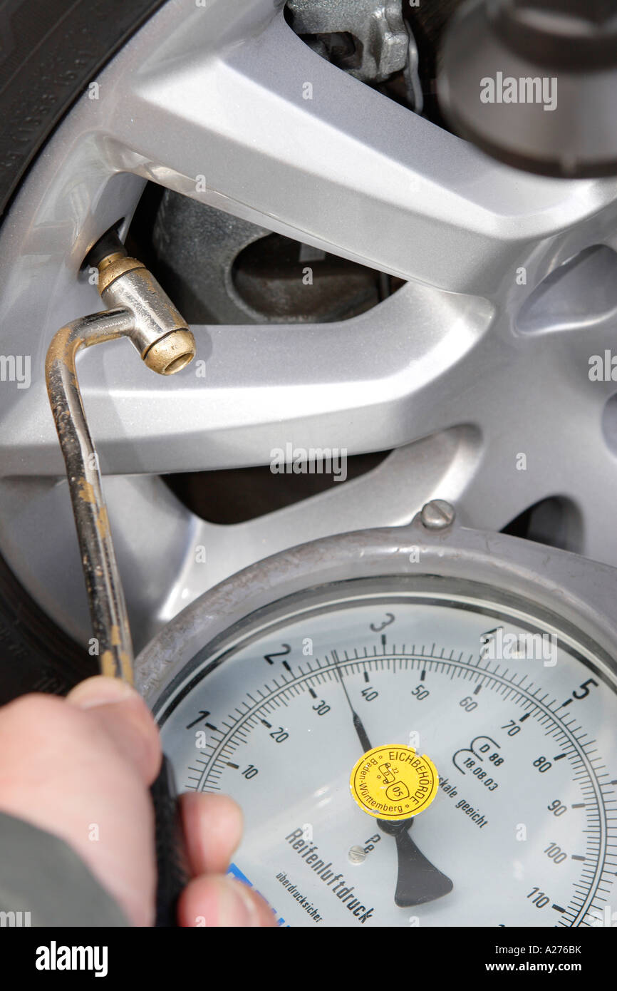 Measuring the pressure of a tyre hi-res stock photography and images ...