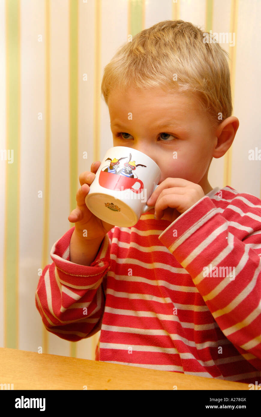 Little boy drinks from cup Stock Photo - Alamy