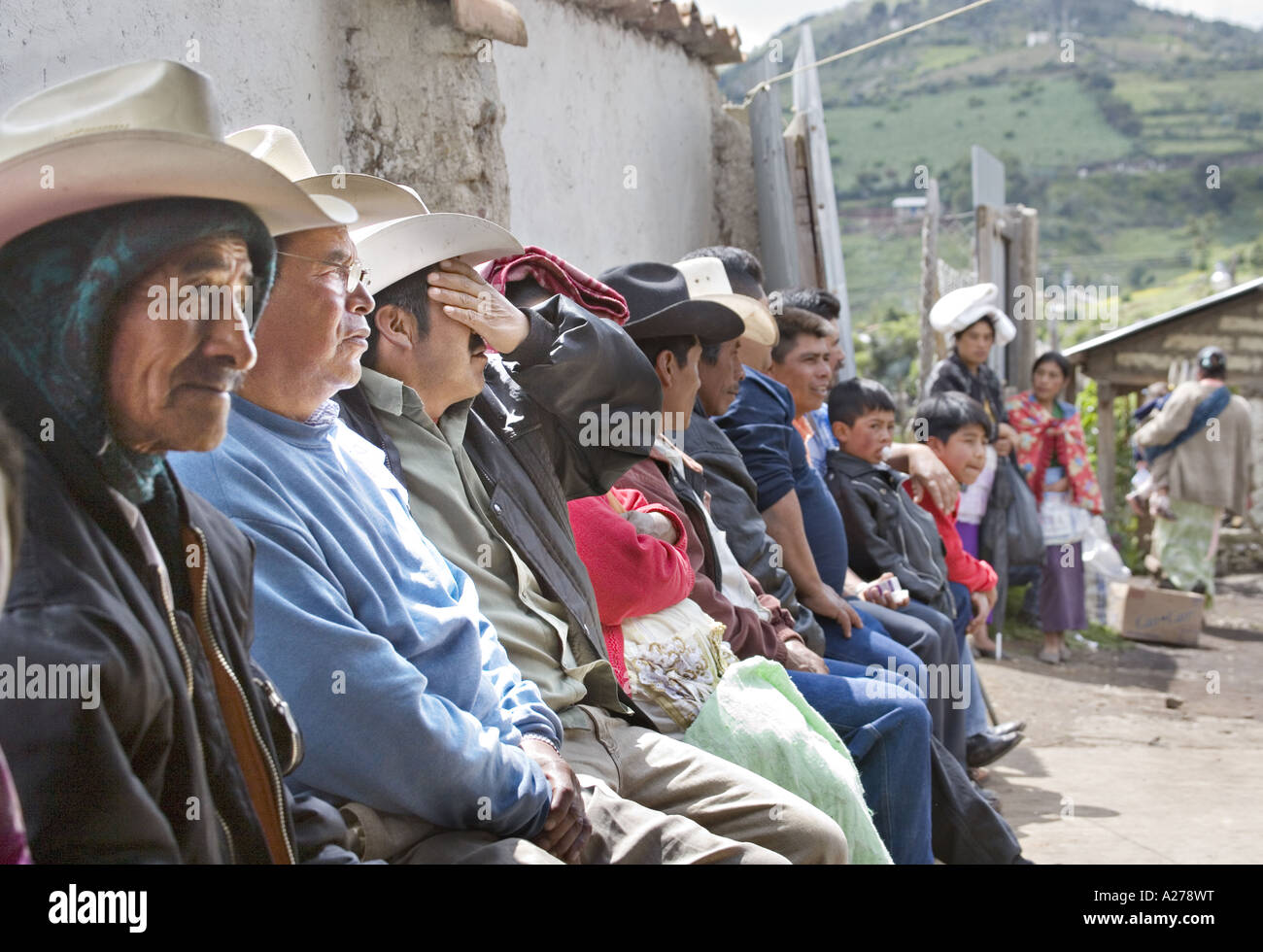 GUATEMALA CAPELLANIA Indigenous Maya Quiche men in cowboy hats wait to ...