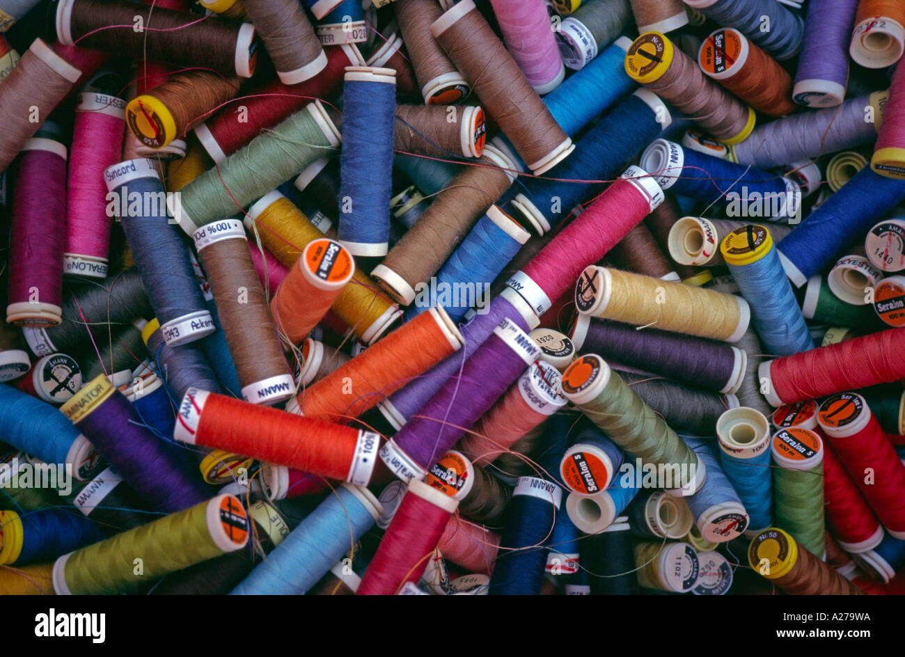 many rolls of sewing thread in differnt colours Stock Photo - Alamy