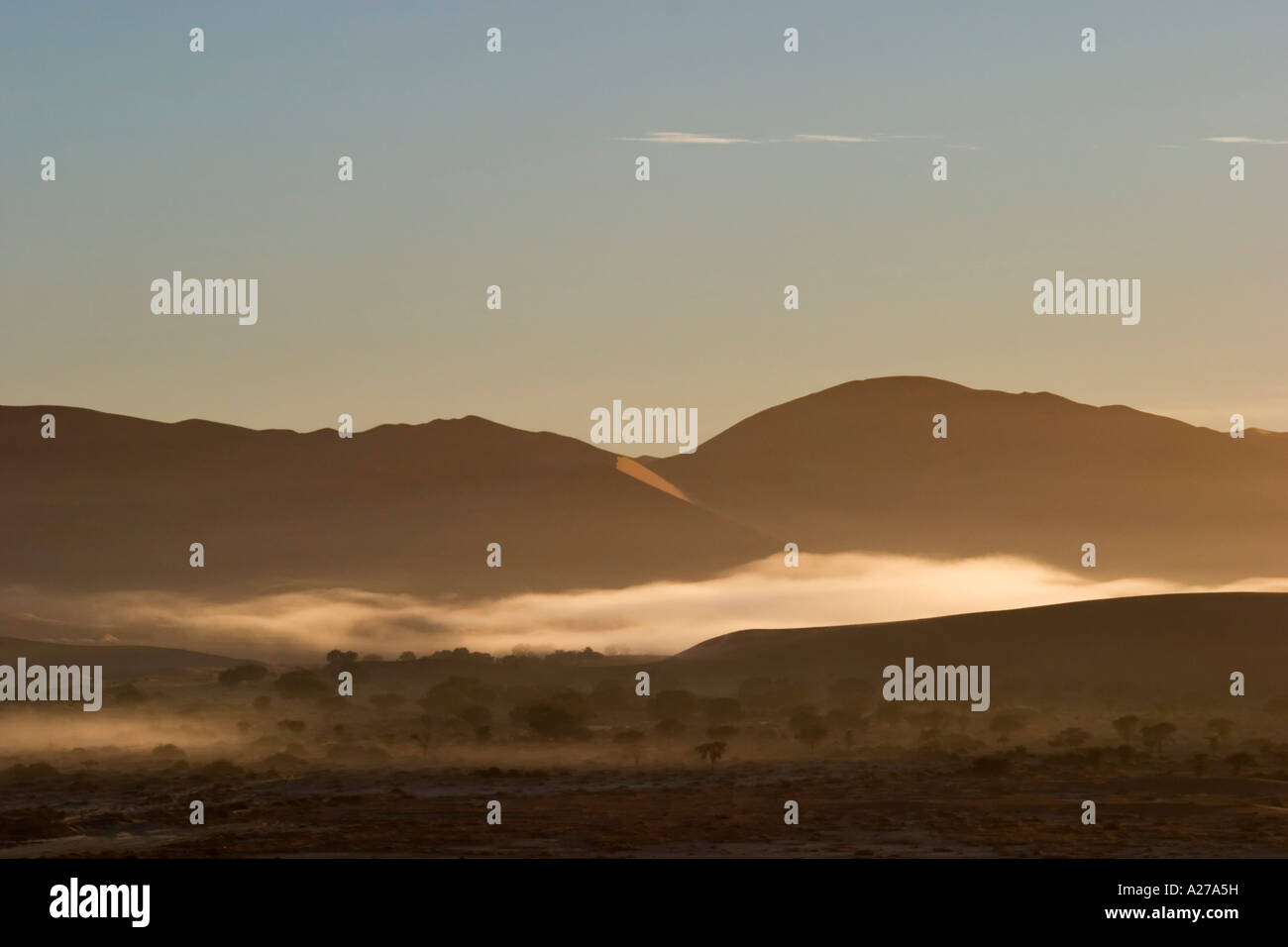 The fog from the ocean (atlantic) between the red dunes. Sossusvlei ...