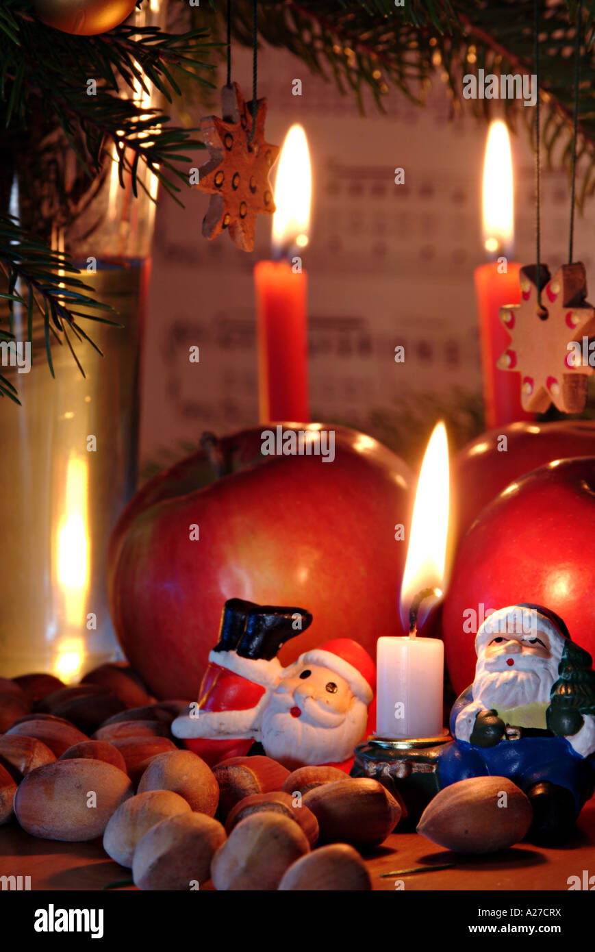 Burning candles, red apples, nuts, Christmas decoration, Santa Claus ...