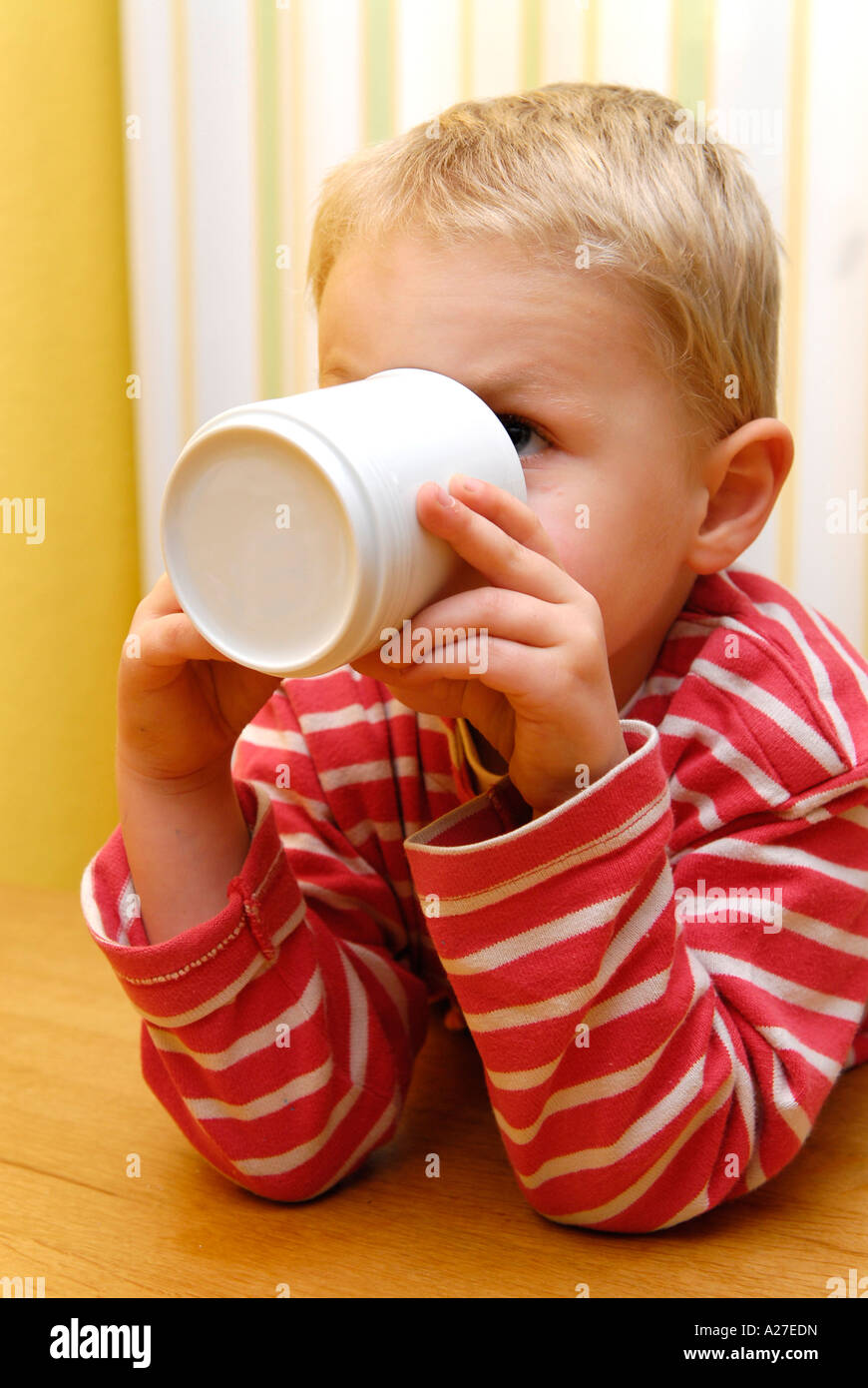 Little boy drinks from cup Stock Photo - Alamy