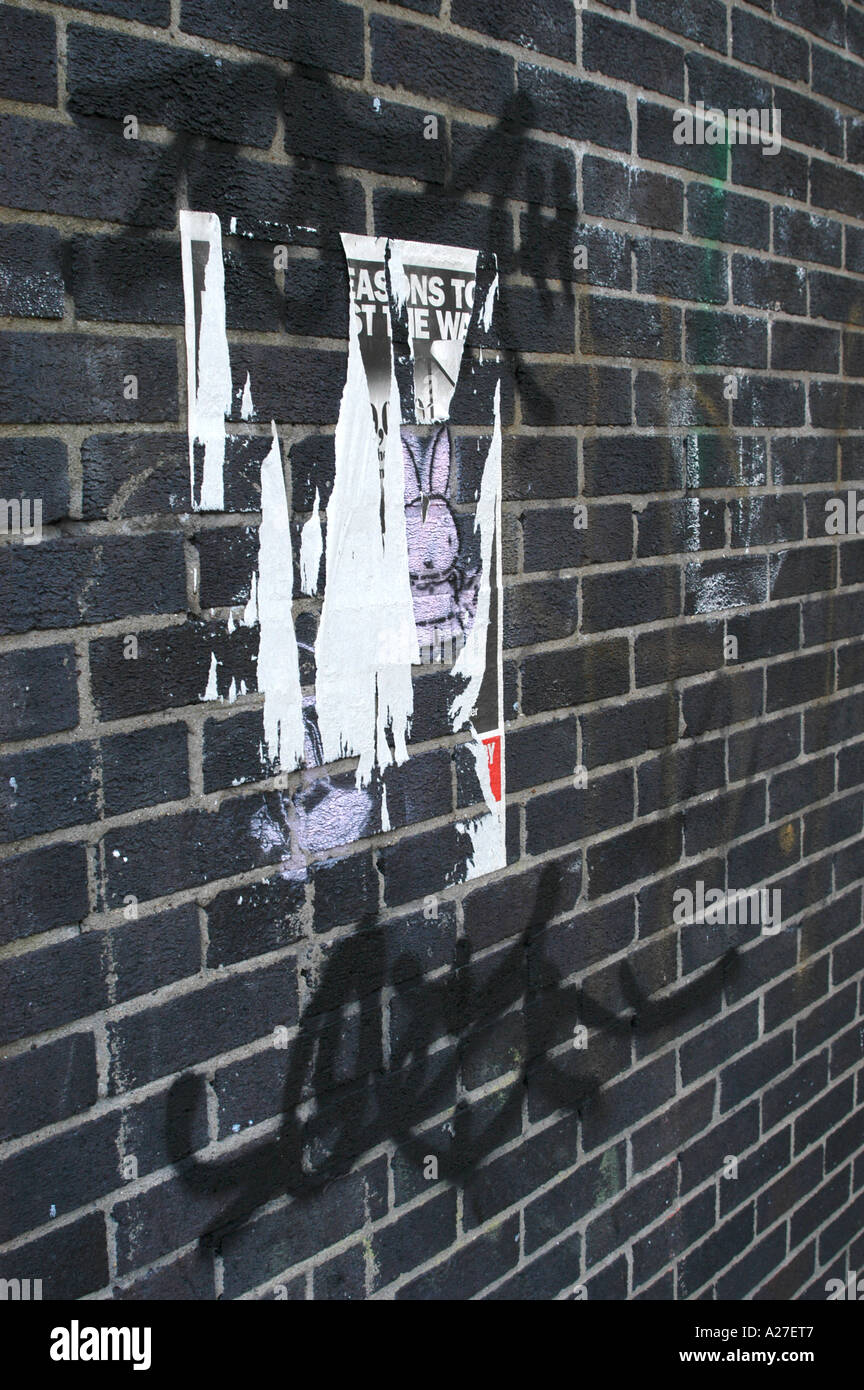 Graffiti and torn poster on wall Stock Photo - Alamy