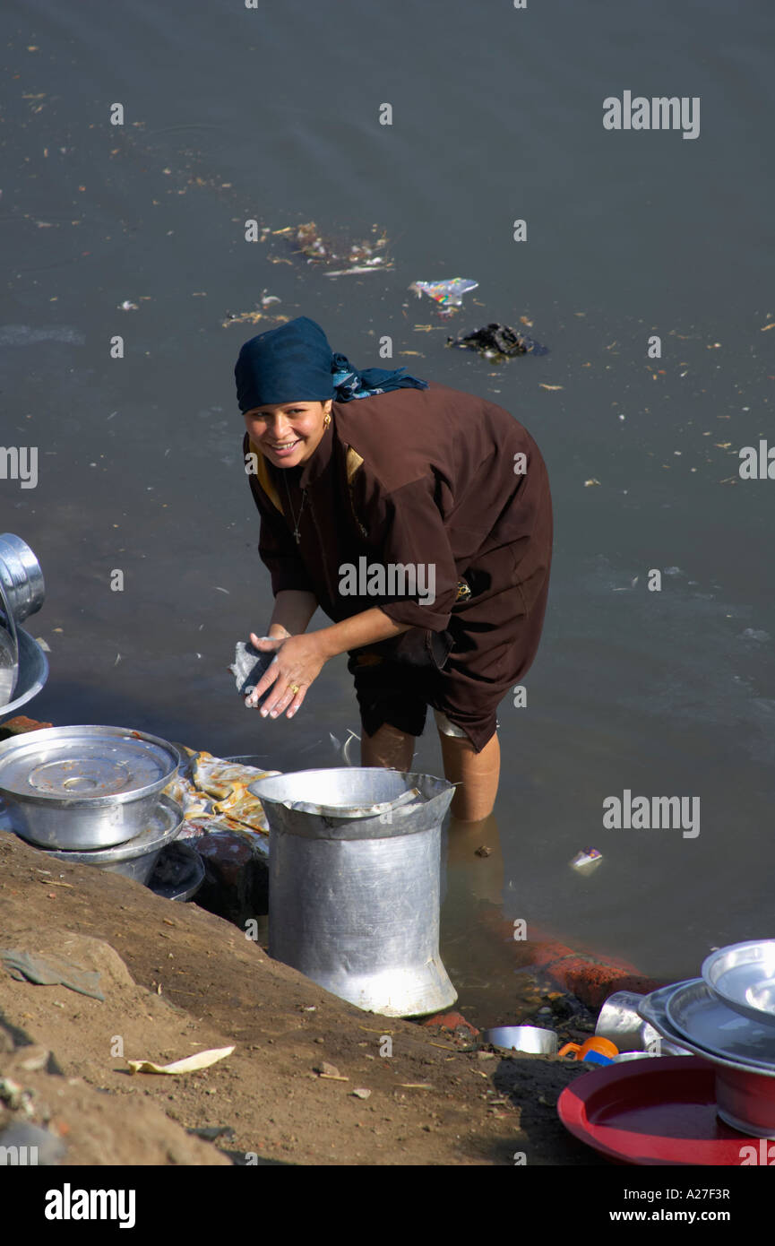 Young Egyptian Woman Washing Pots In the Nile River Stock Photo - Alamy