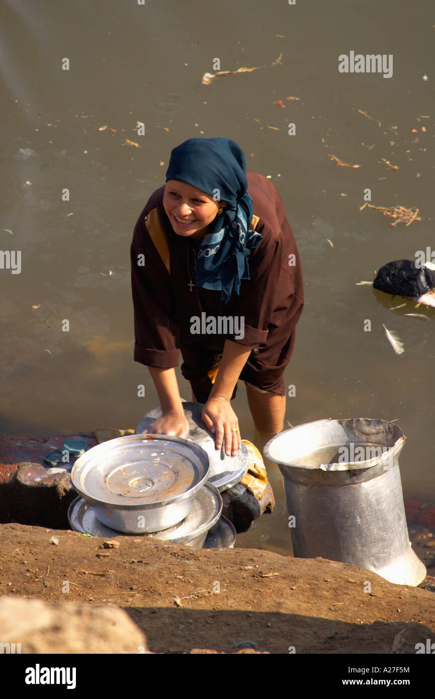 Egyptian Girl Washing Pots In the River Nile Stock Photo - Alamy