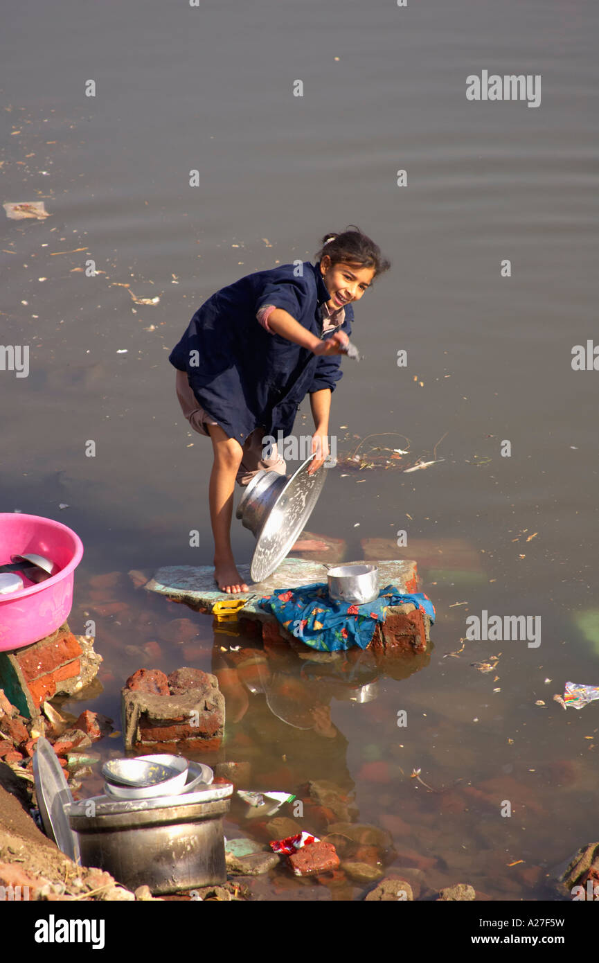 Egyptian Girl Washing Pots In the River Nile Stock Photo - Alamy