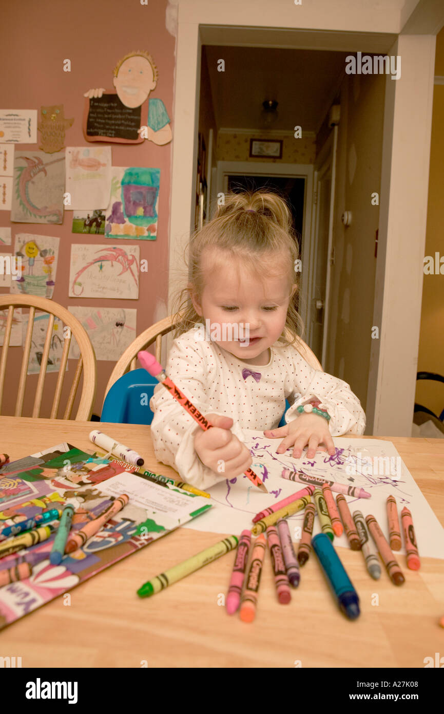 Child Coloring With Crayons