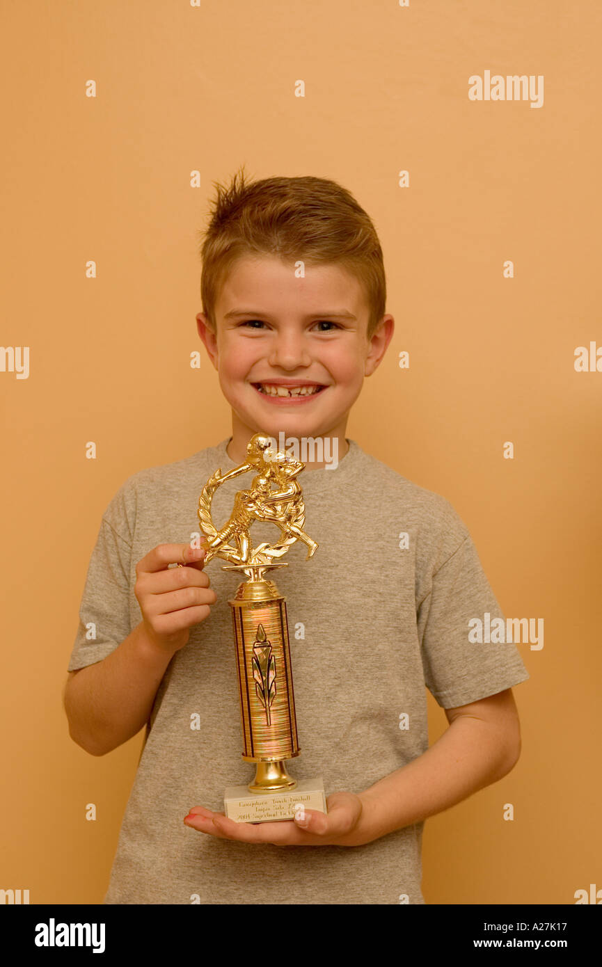Boy 10 holding football trophy Stock Photo - Alamy