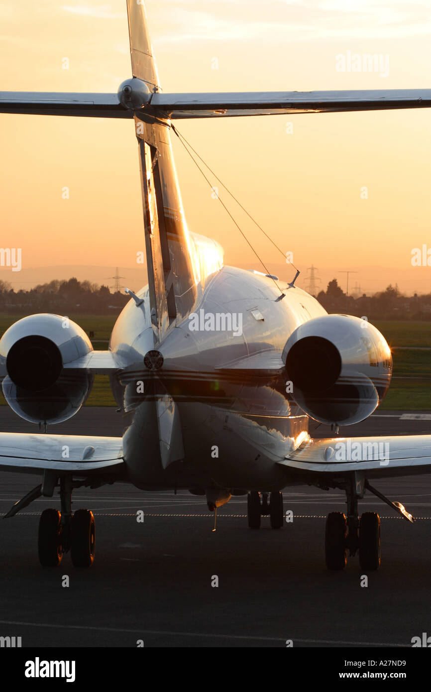 Business executive jet aircraft in evening sunset at an airport on a ...