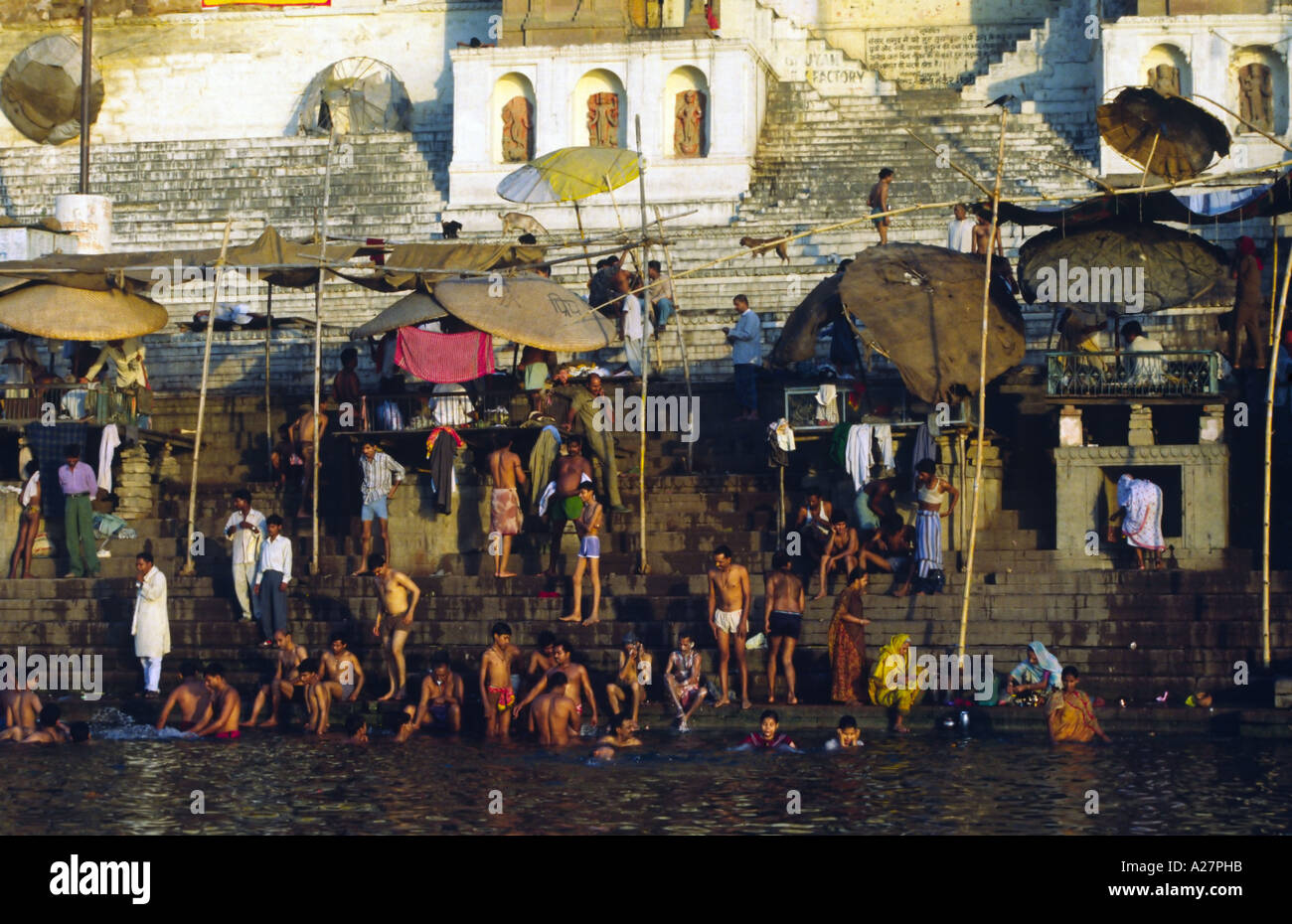 Men washing and bathing in the sacred river Ganges, Benares, India ...
