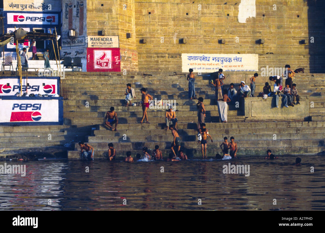 Men washing and bathing in the sacred river Ganges, Benares, India with ...