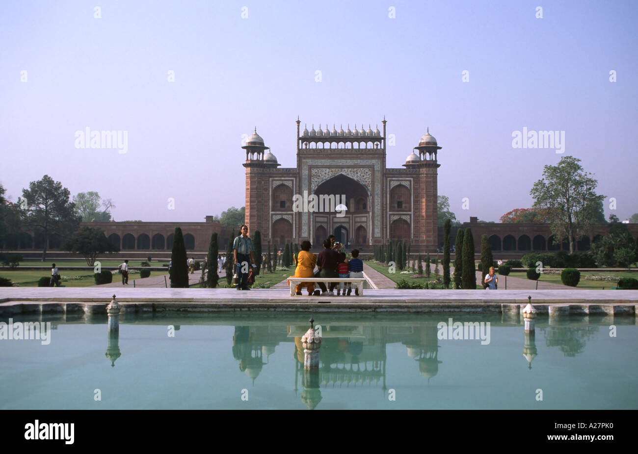 Indians on bench in front of main gateway to Taj Mahal India Stock ...