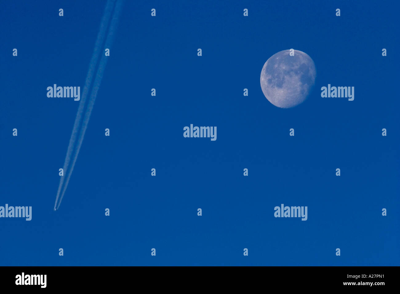 A jet plane flying past a full moon in scenic Saskatchewan Canada Stock ...
