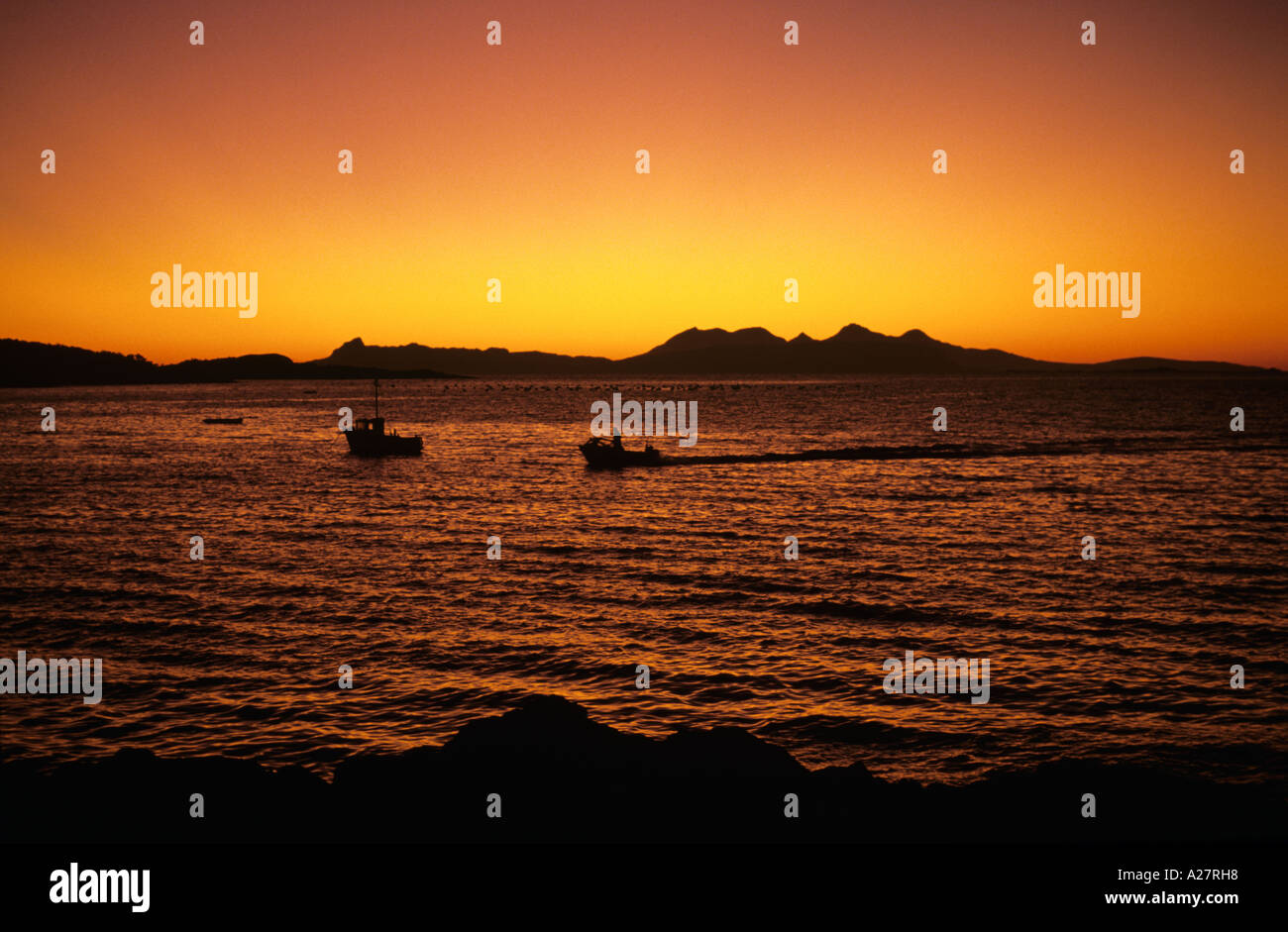 View of Skye with fishing boats from Roshven Scotland UK Stock Photo ...