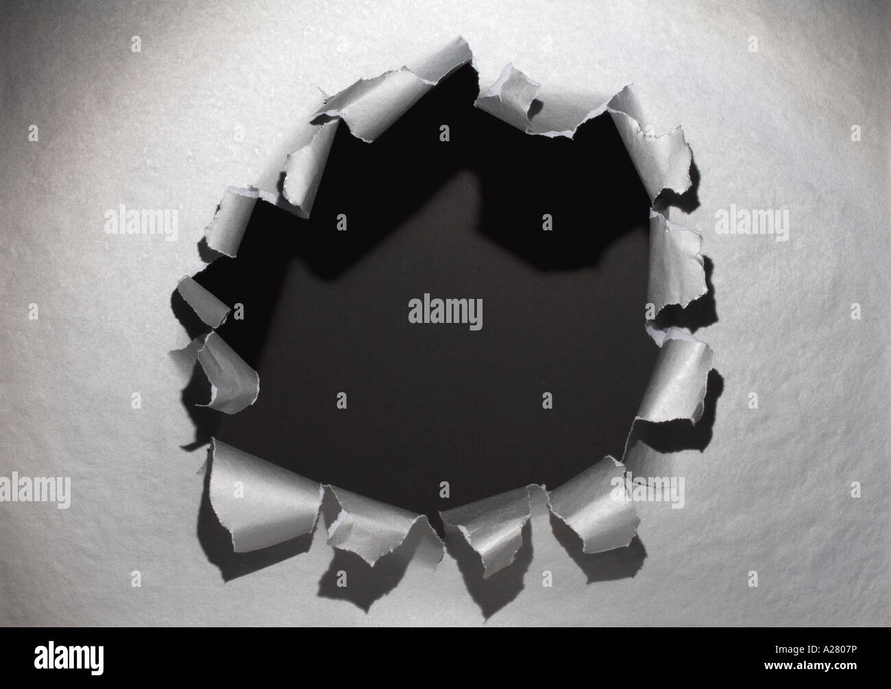 Torn through hole Stock Photo - Alamy