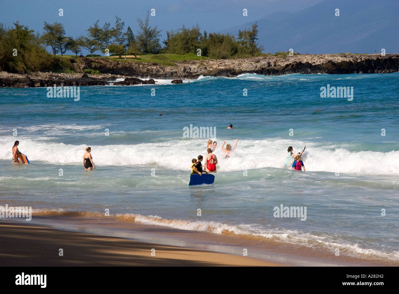 Boogie boarding on waves in the pacific ocean off the island of Maui ...