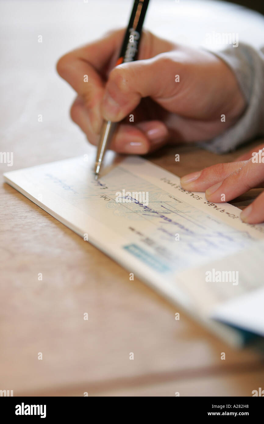 Writing A Cheque Stock Photo - Alamy