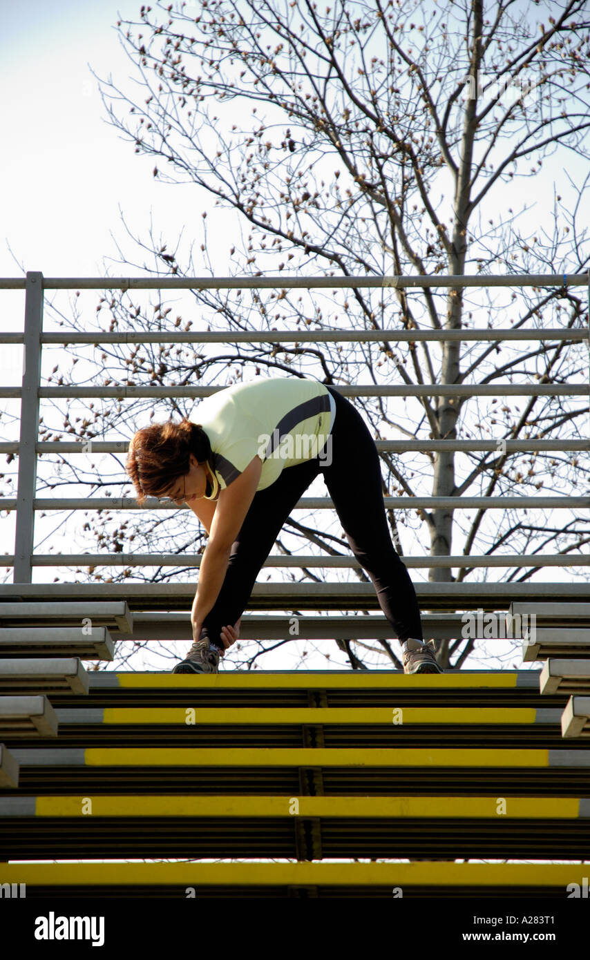 Adult woman training in stadium steps Stretching legs Stock Photo - Alamy