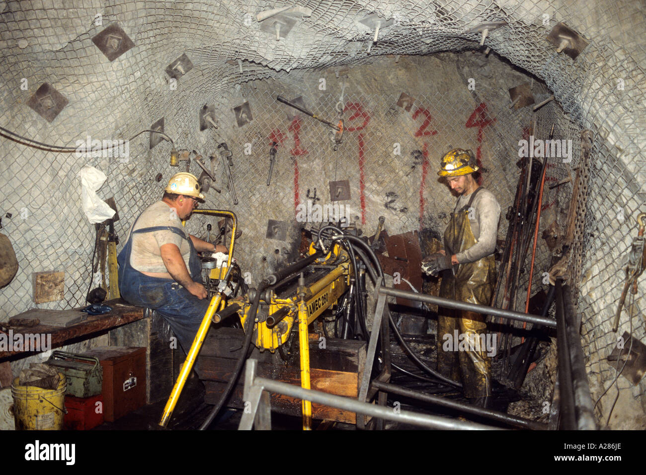 Miners drilling holes for dynamite with a pneumatic drill in the Lucky ...