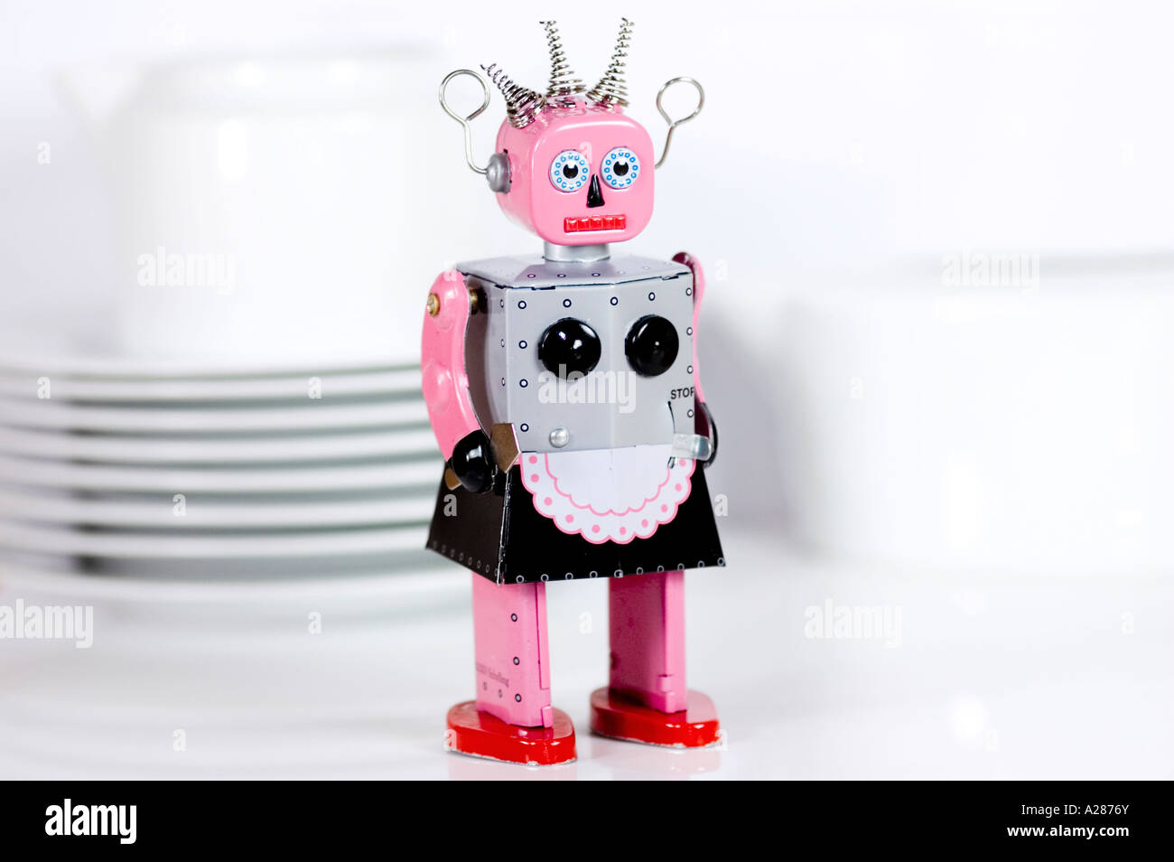 Female tin toy robot standing in front of dishes Stock Photo - Alamy