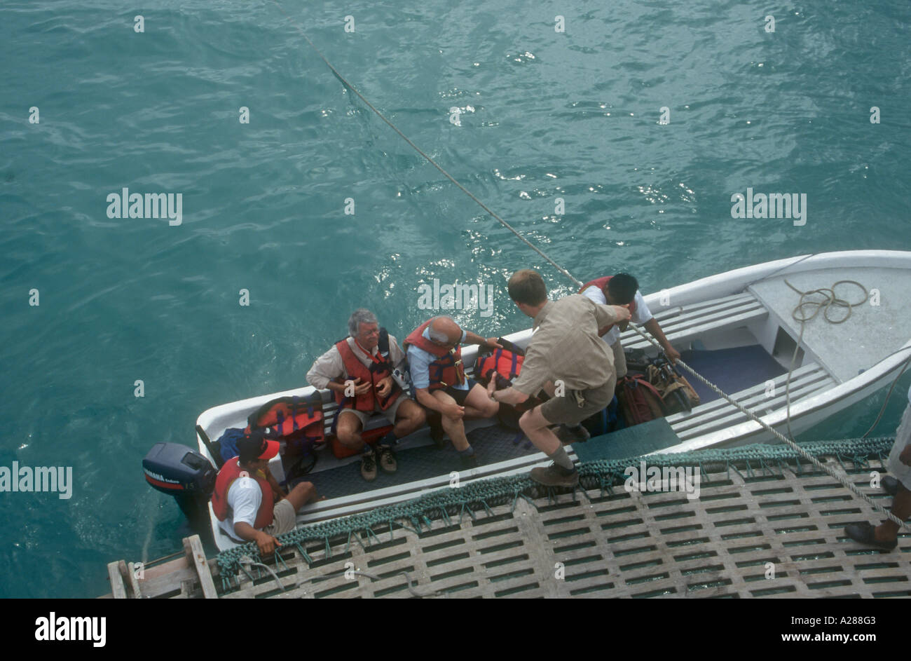 intrepid travellers boarding boat Galapagos Islands Stock Photo - Alamy