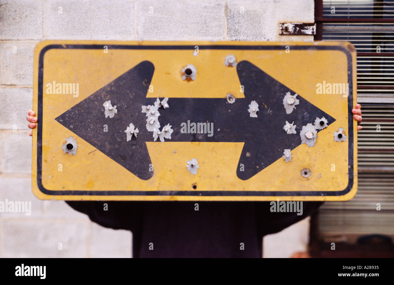 road sign being held up by hidden person Stock Photo - Alamy