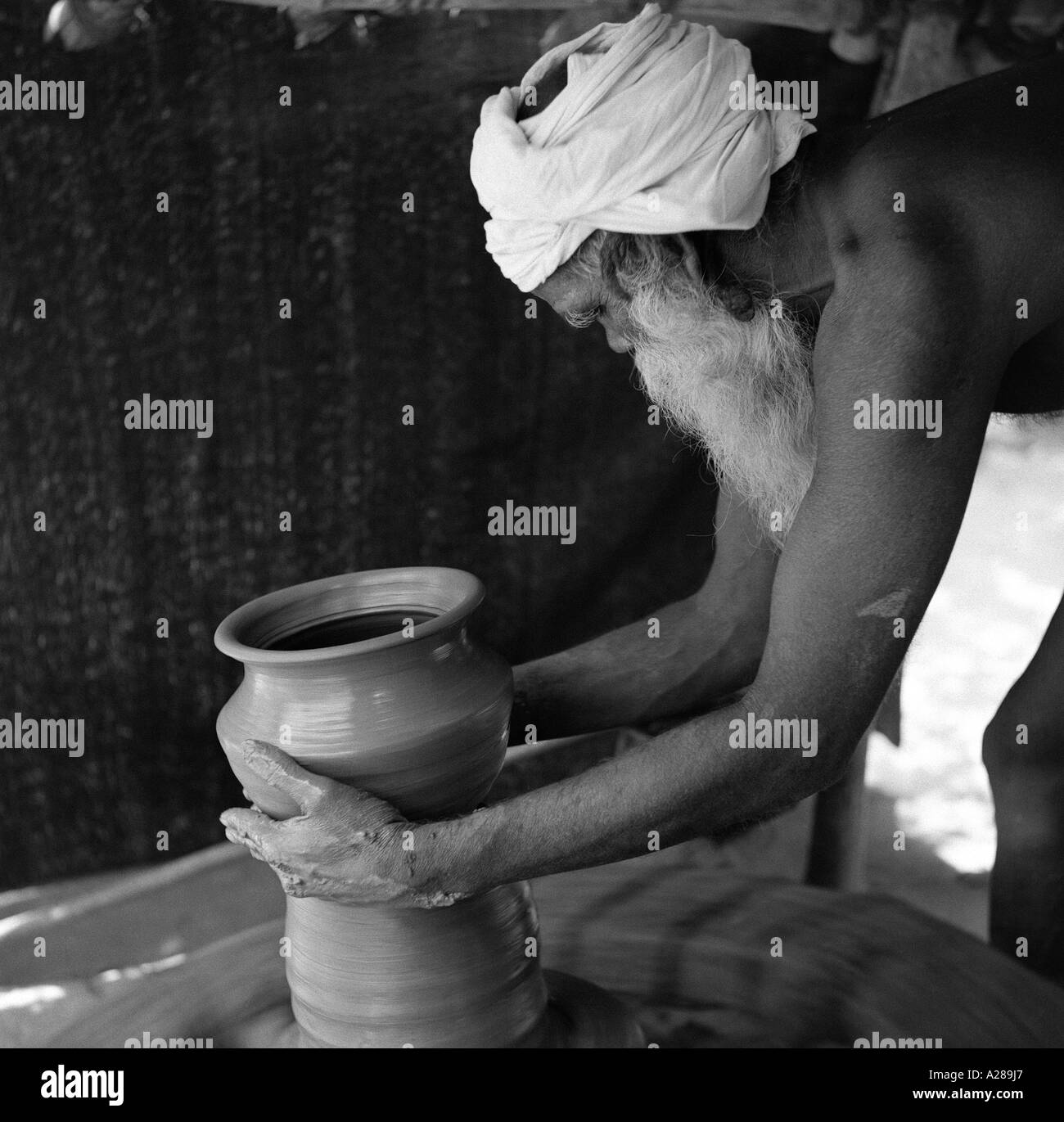 Man potter creating a pot with his two bare hands, pottery, Tamil Nadu ...
