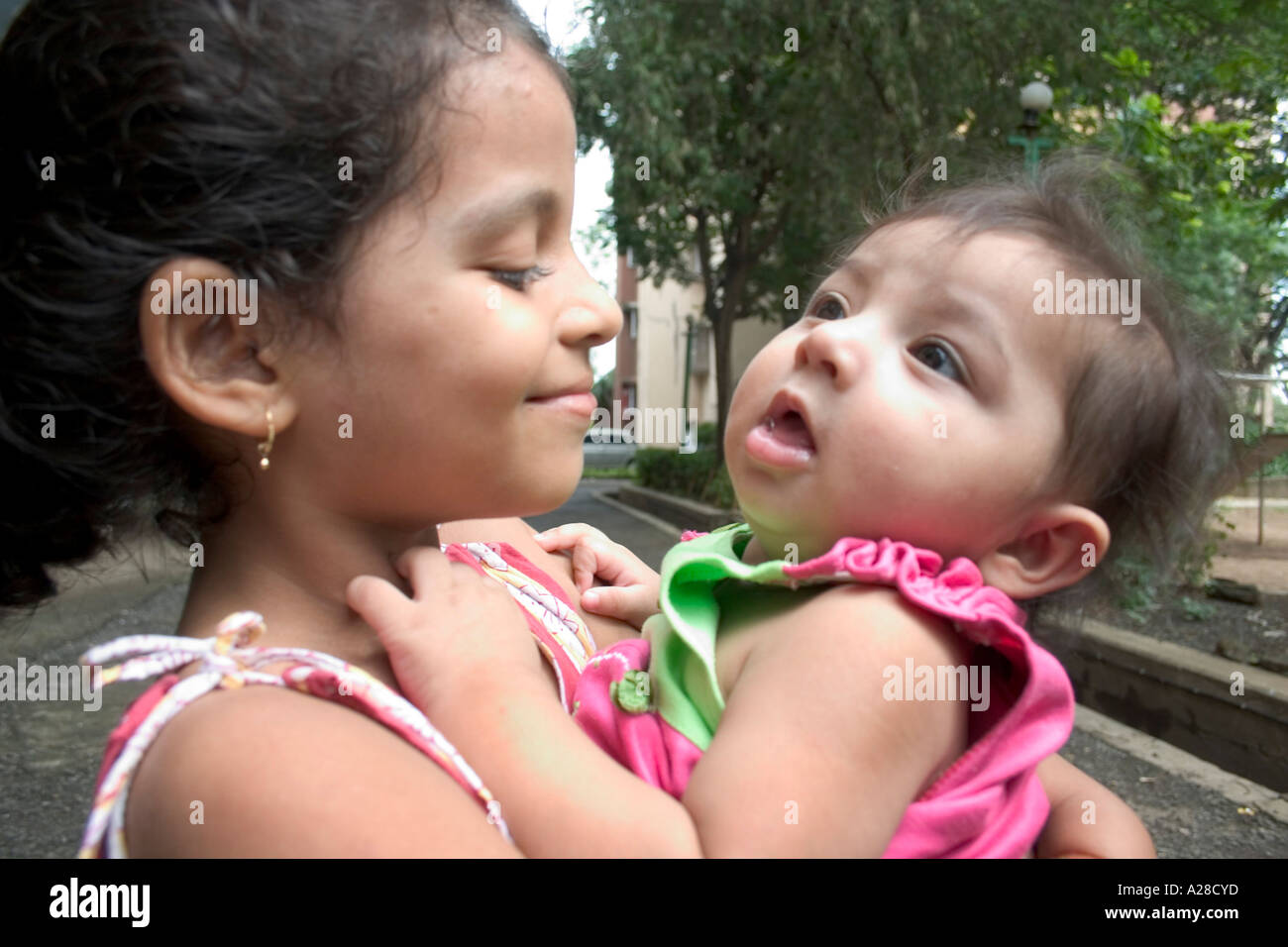 RSC76708 Two girls pleasure of holding a baby Mumbai Bombay Maharashtra ...