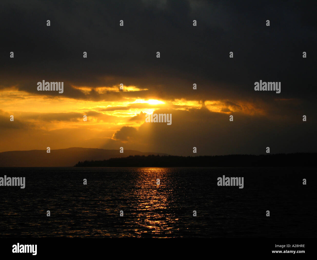 Sun peeking over cloud at coast hi-res stock photography and images - Alamy