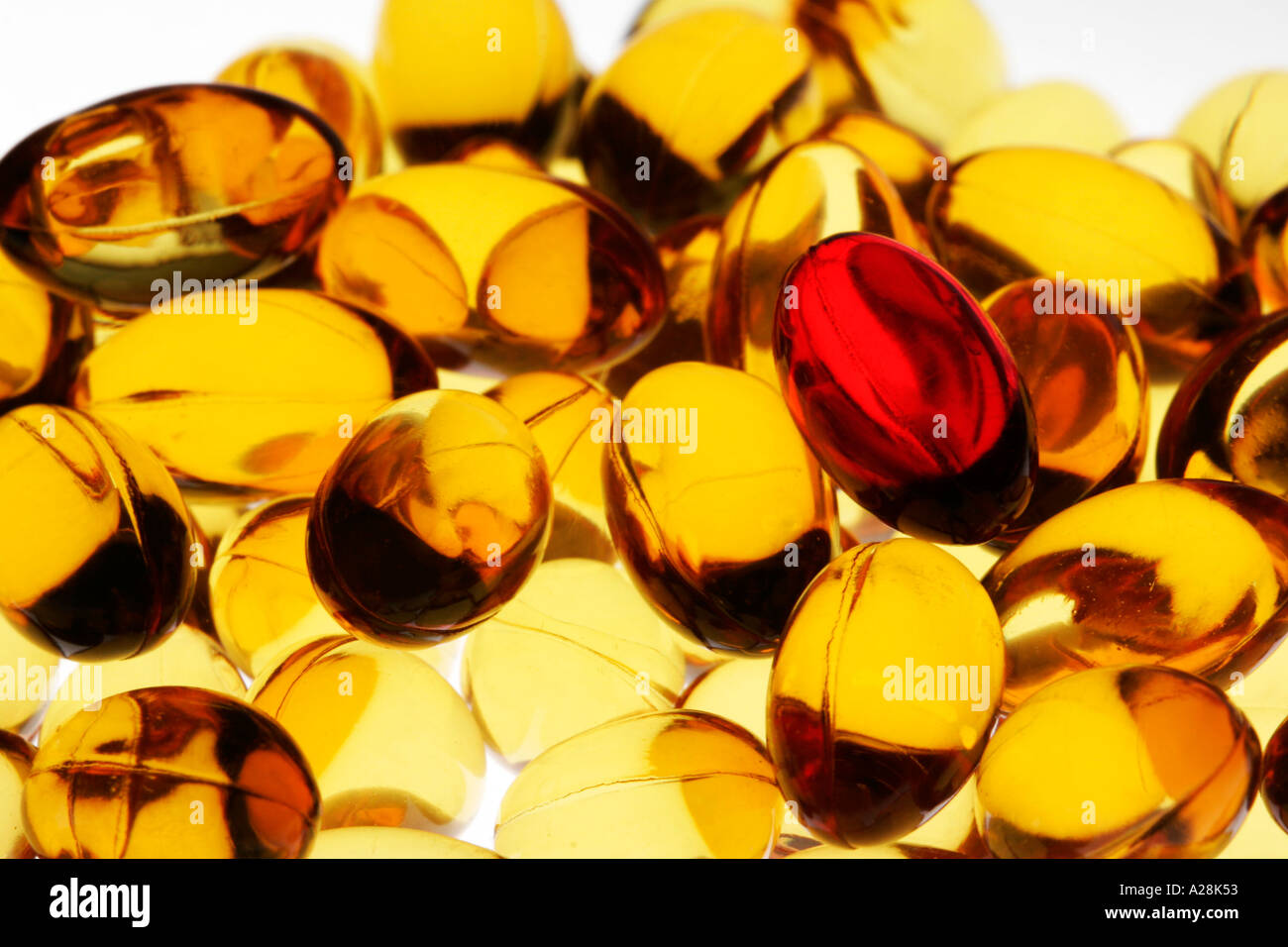 Amber capsules plus red capsule Stock Photo - Alamy