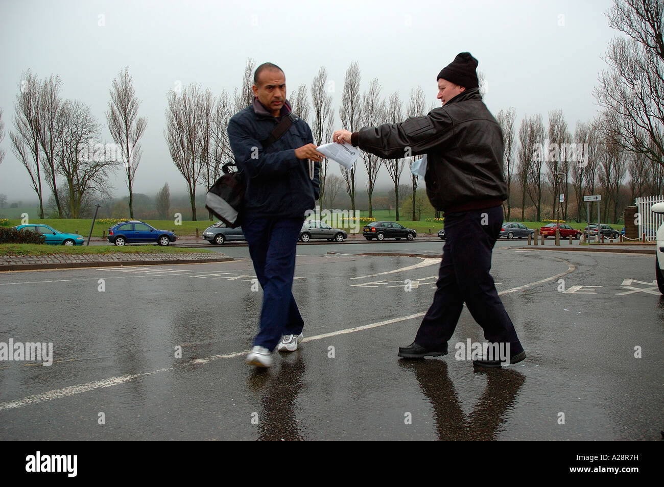 man handing out leaflets Stock Photo - Alamy
