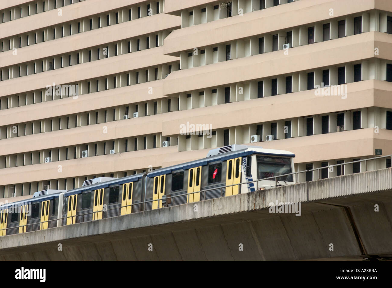 LRT train in Malaysia moving in front of a building 2005 Stock Photo ...