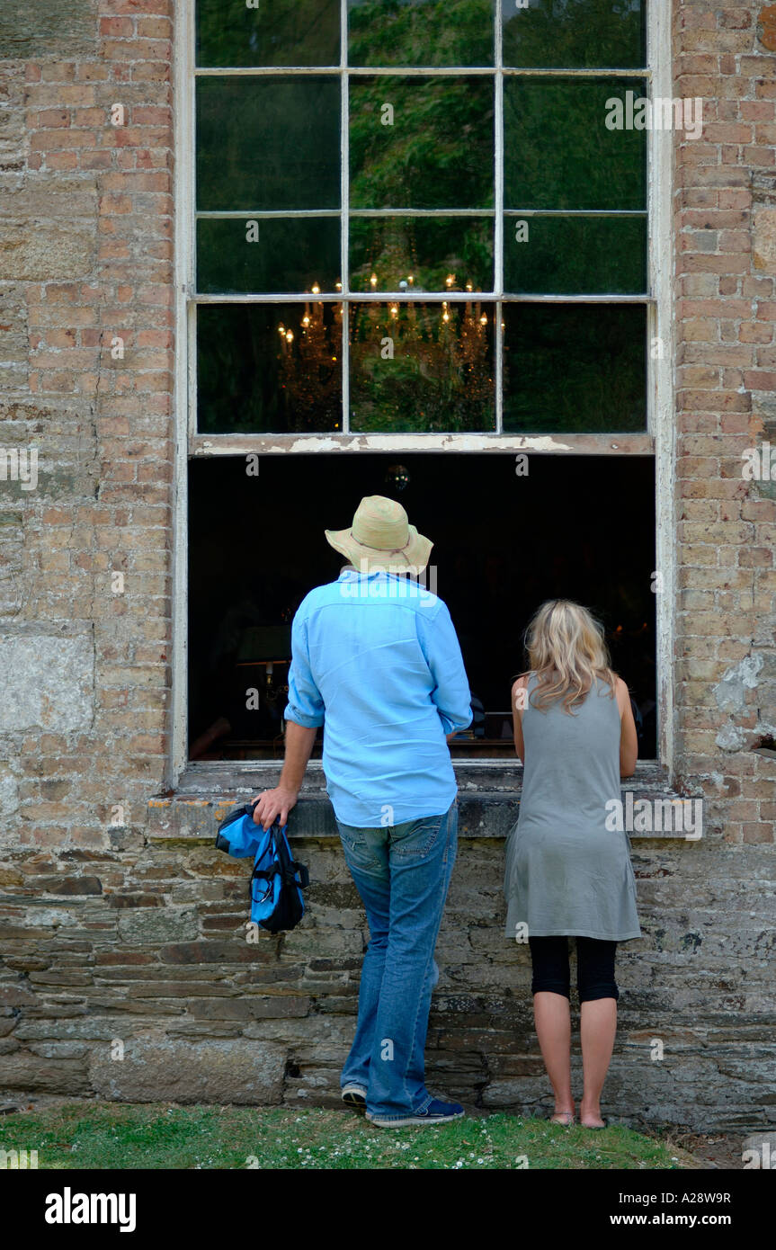 People looking into the house through the window Stock Photo - Alamy