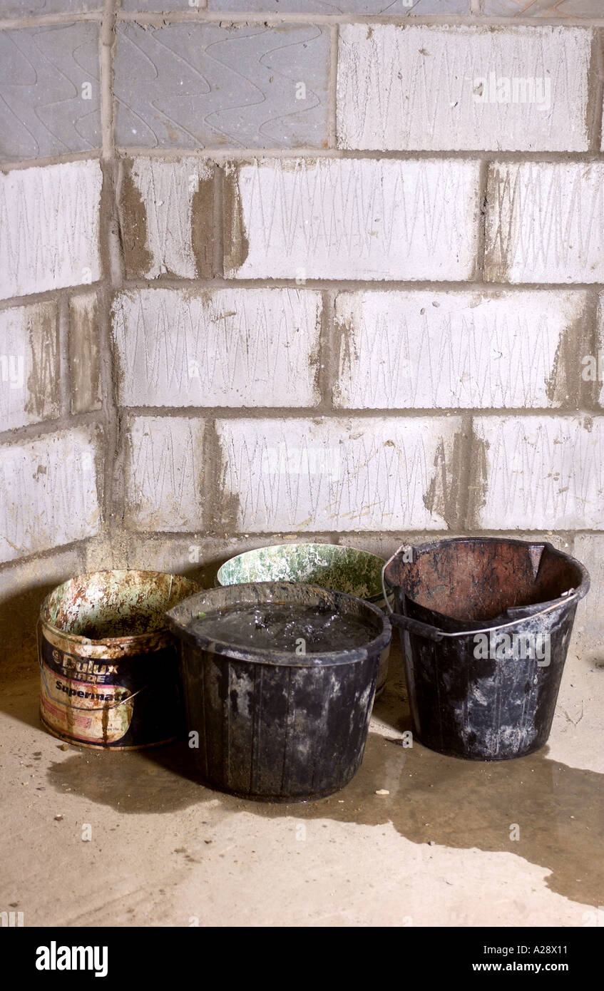 BUILDERS BUCKETS CATCHING RAIN WATER IN AN EXTENSION Stock Photo - Alamy
