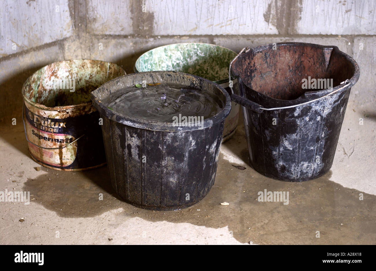 BUILDERS BUCKETS CATCHING RAIN WATER IN AN EXTENSION Stock Photo - Alamy