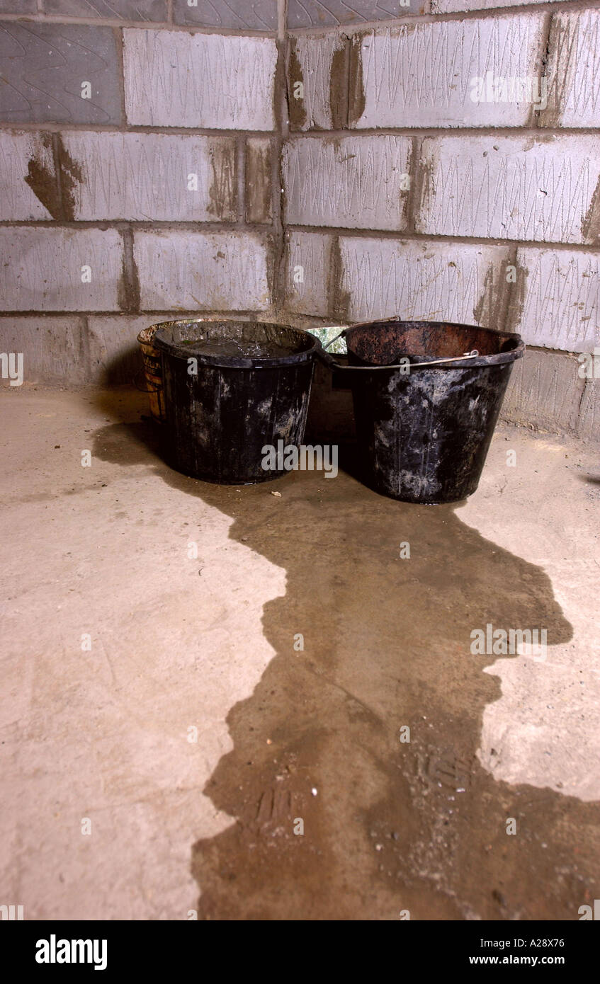 BUILDERS BUCKETS CATCHING RAIN WATER IN AN EXTENSION Stock Photo - Alamy
