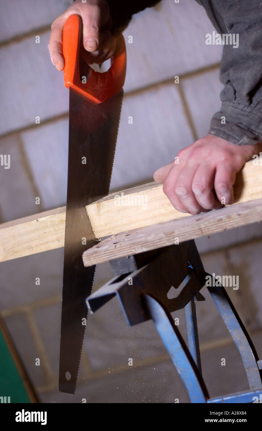 A CARPENTER SAWING TIMBER ON A WORK BENCH Stock Photo - Alamy