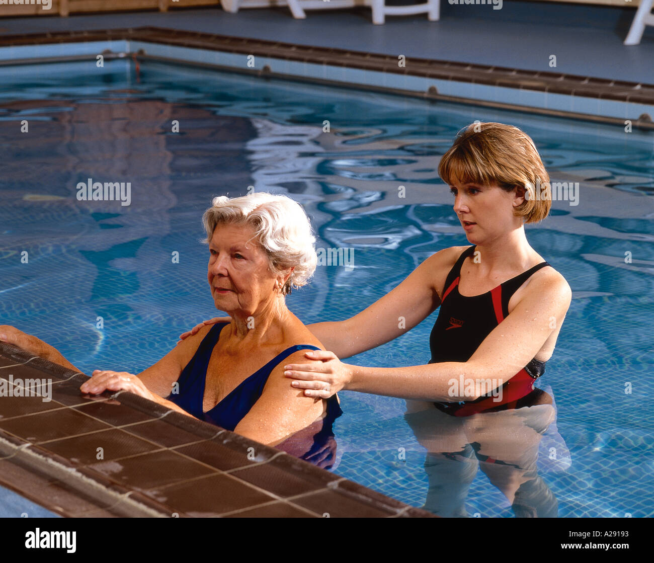 PHYSIOTHERAPIST IN SWIMMING POOL WITH PATIENT Stock Photo - Alamy