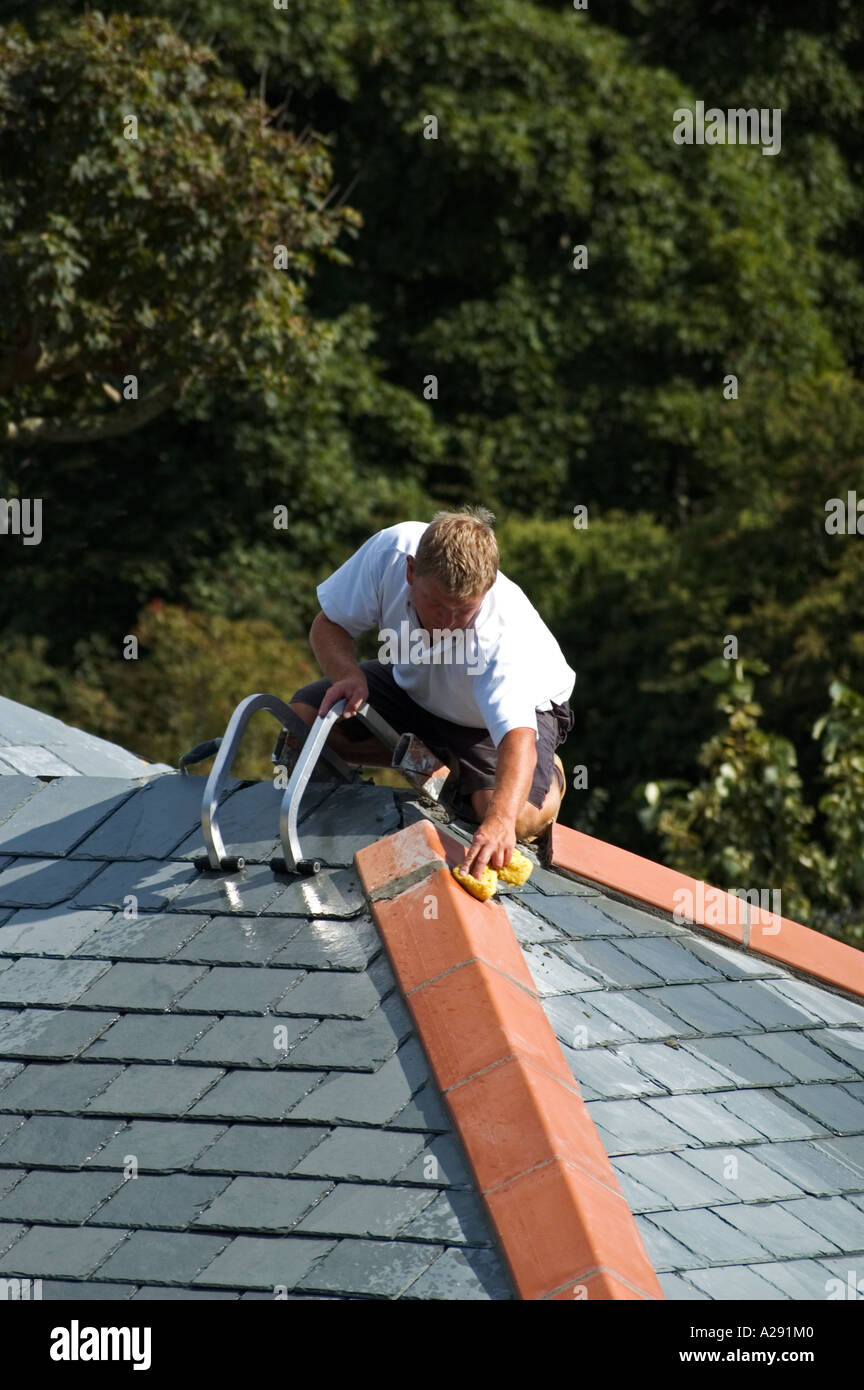 a builder fixing roof Stock Photo - Alamy