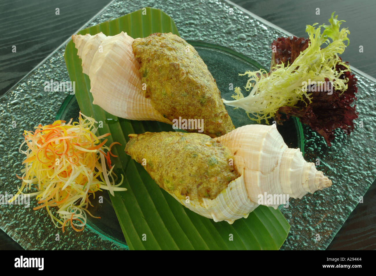 Baked stuffed conch with goose liver and fresh fungus Stock Photo - Alamy