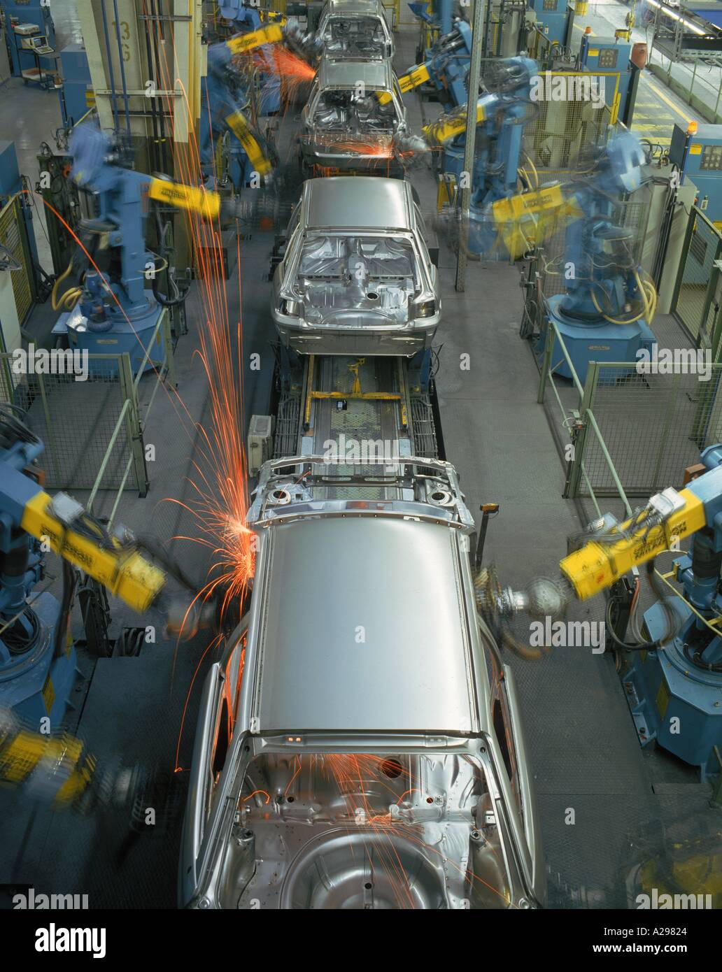 Robots welding on a production line in a car factory H P Merten Stock Photo - Alamy