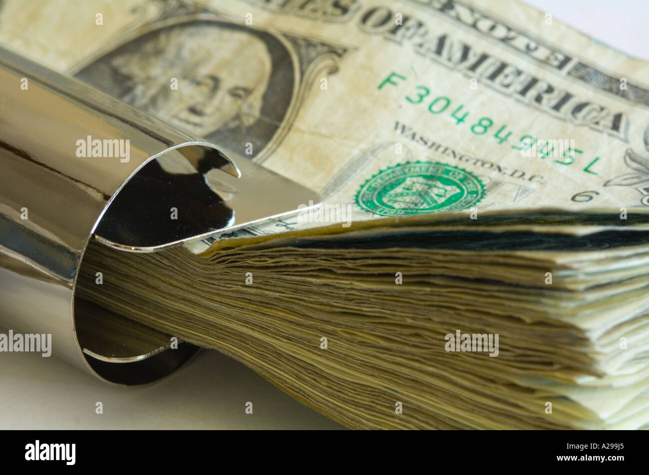 conceptual view of a stack of one dollar bills US clamped together ...