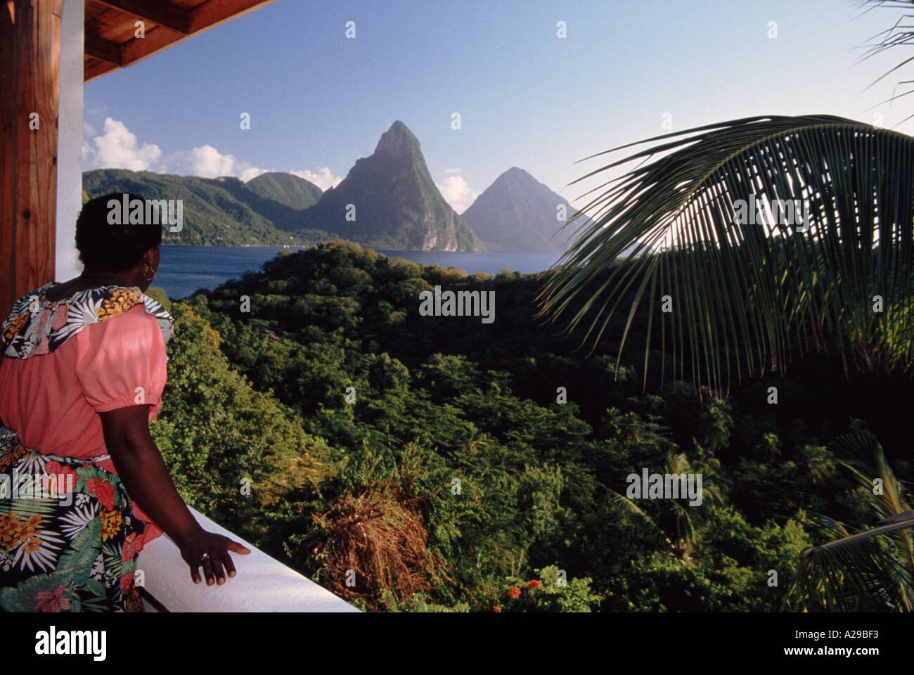 Woman enjoying view of The Pitons from hotel room balcony St Lucia ...