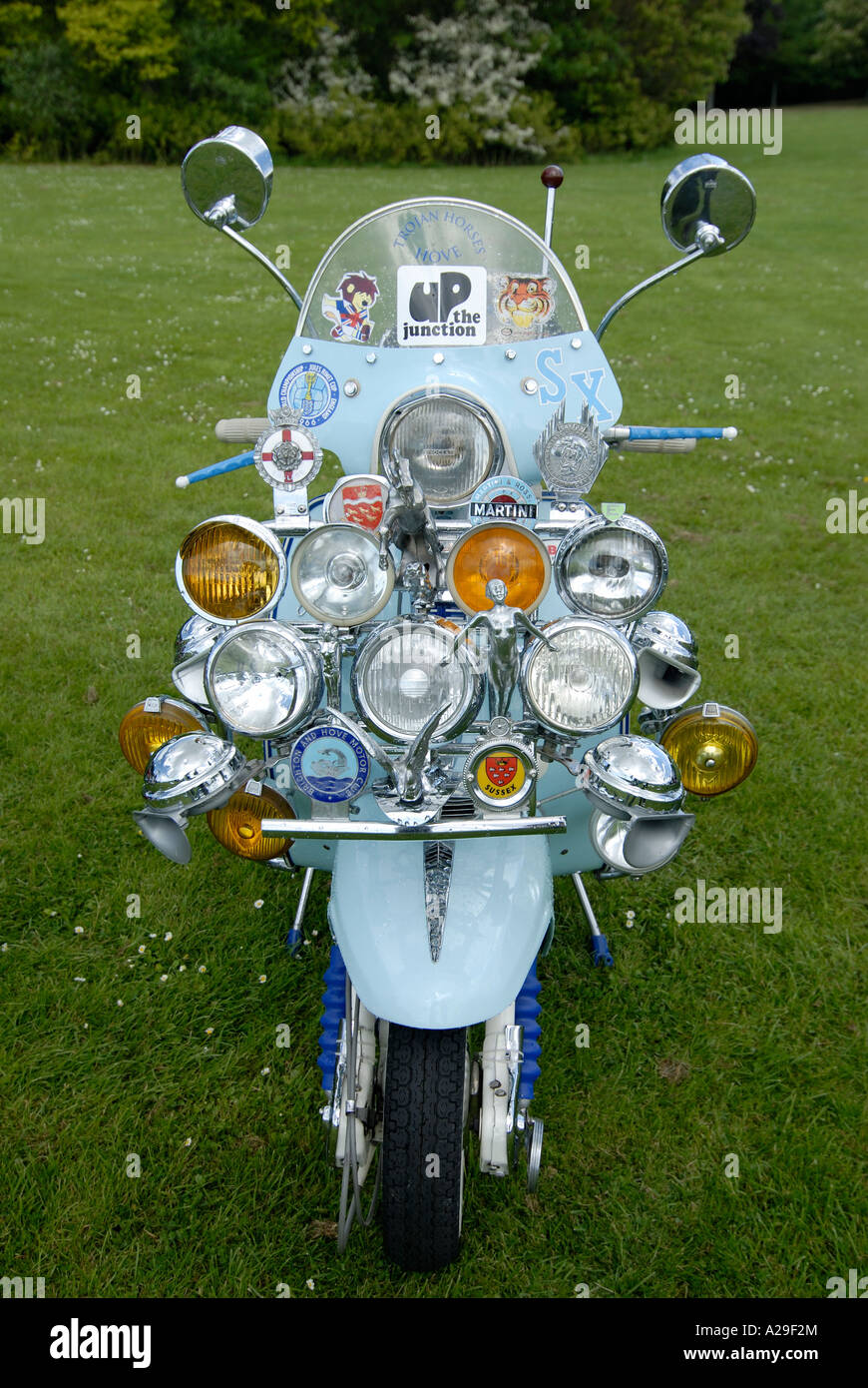 A light blue Lambretta scooter customized with the addition of many ...