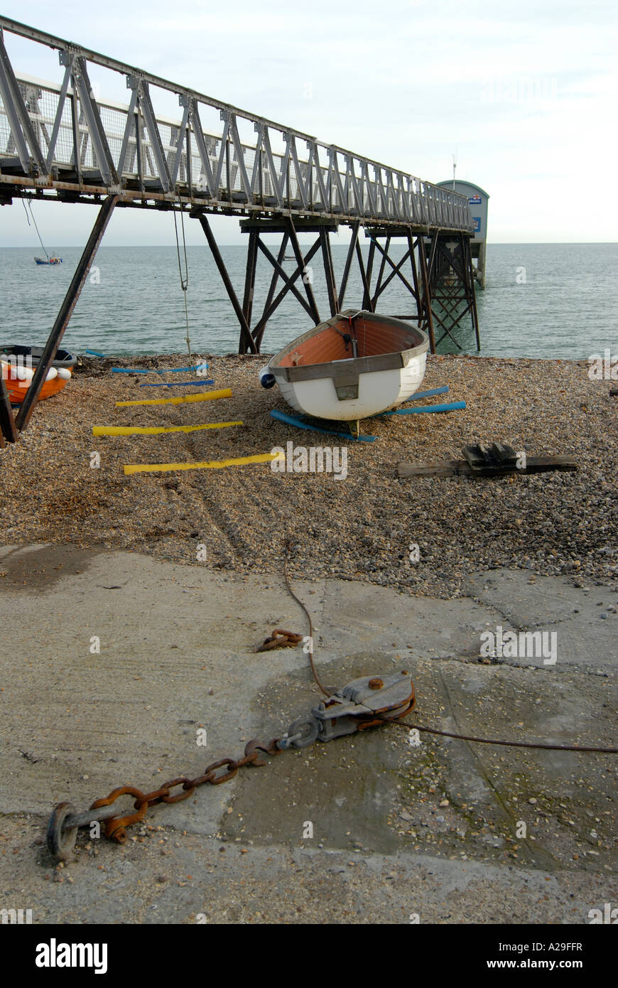 Selsey lifeboat house and launch with small fishing boat and pulley in ...
