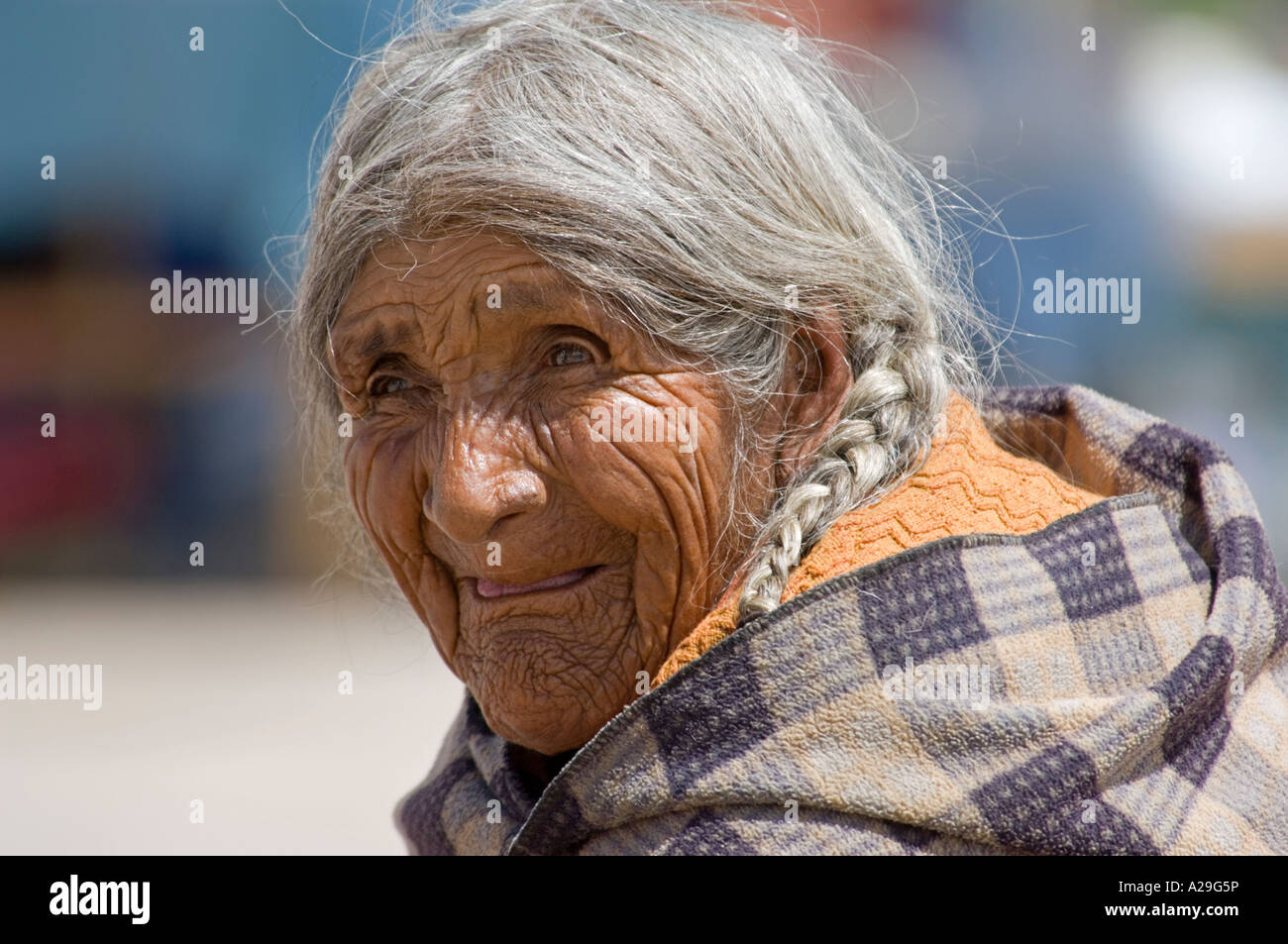 A head and shoulder portrait of a wrinkled old lady smiling for the ...