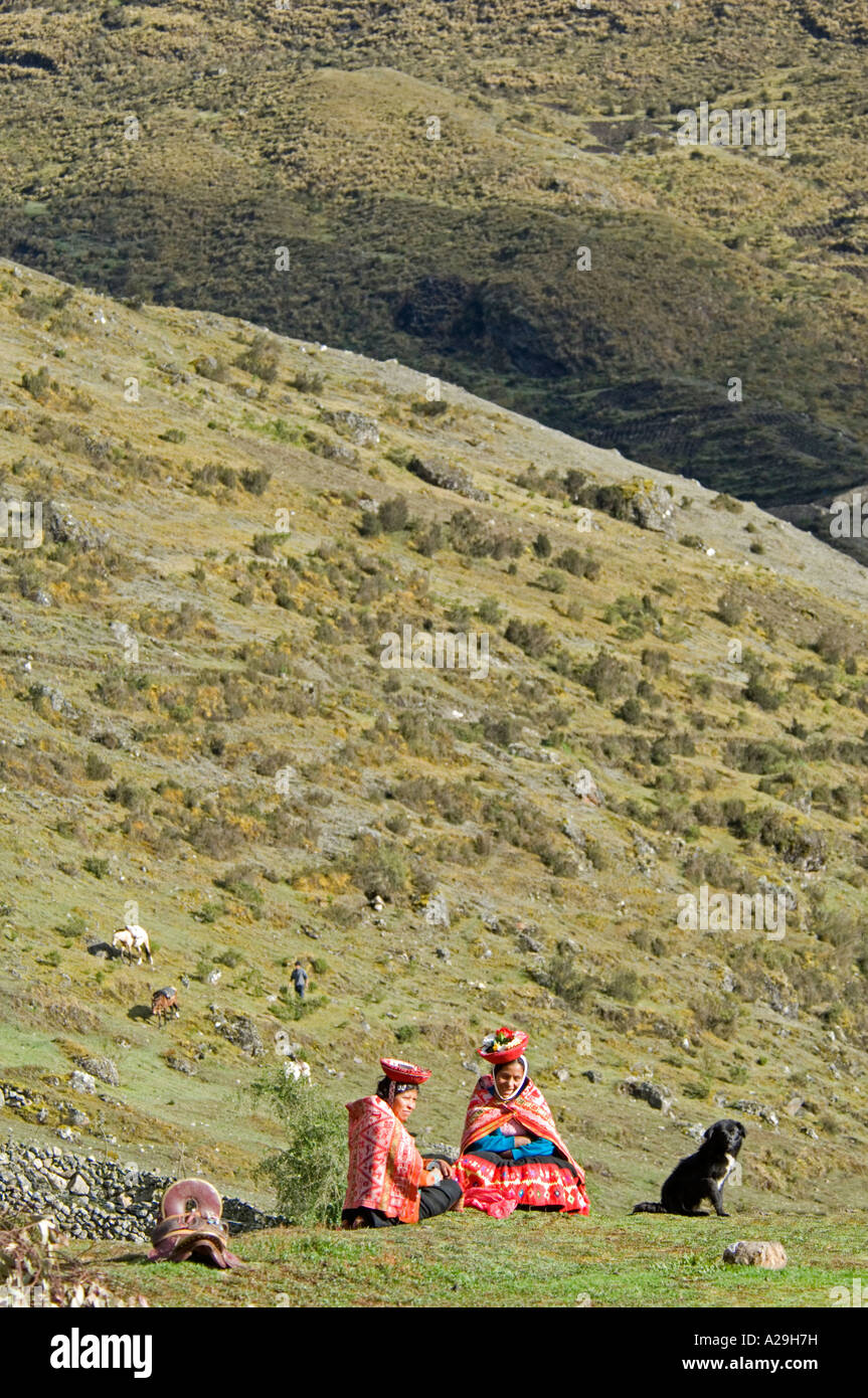 Local Peruvian females in traditional dress visit the base camp at the ...