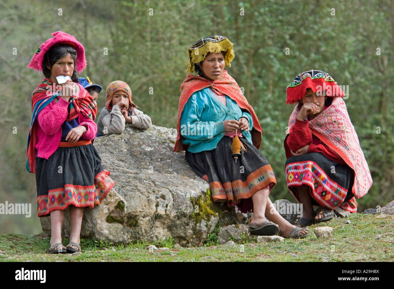 Local Peruvian people in traditional dress visit the base camp at the ...