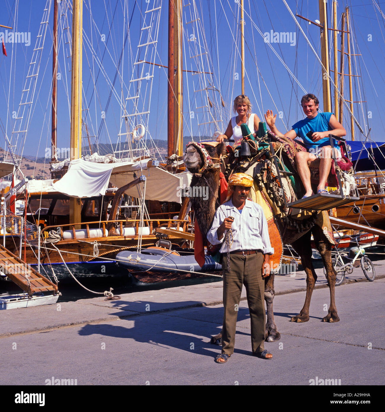 TOURIST COUPLE RIDING A CAMEL IN BODRUM TURKEY Stock Photo - Alamy